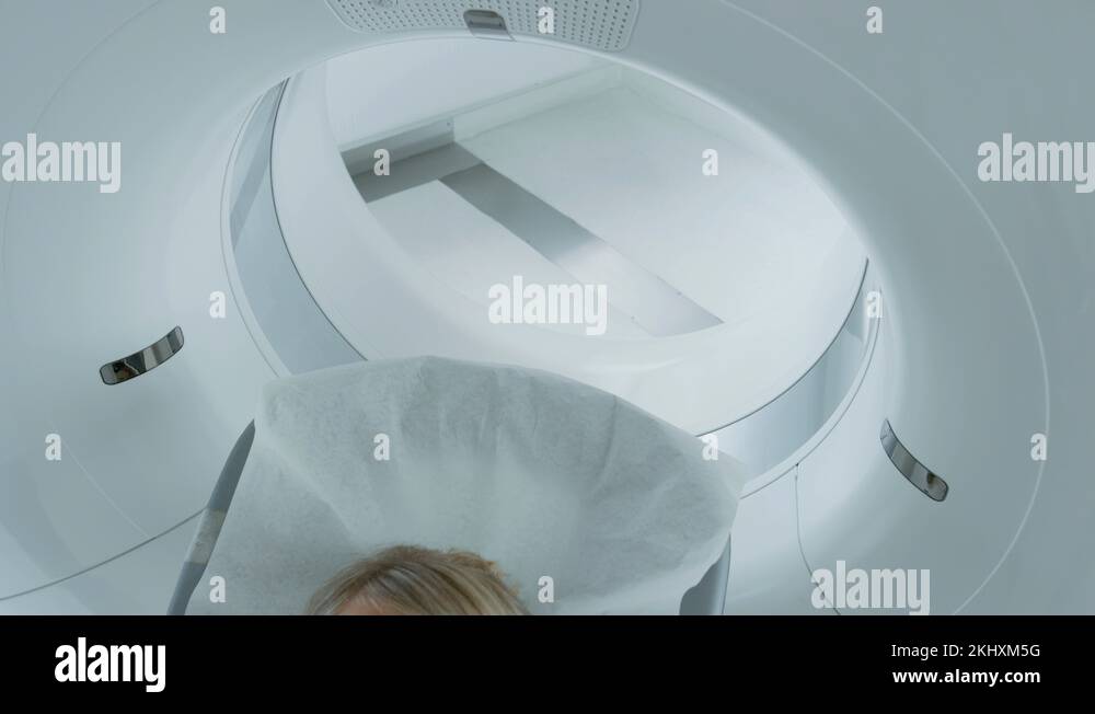Female Patient Lying on a CT or MRI Scan Bed, Moving Machine Scans Her ...