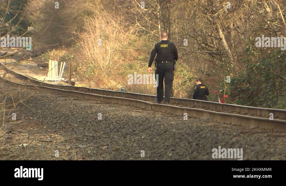 COP WALKING ON RAILROAD TRACKS Stock Video Footage - Alamy