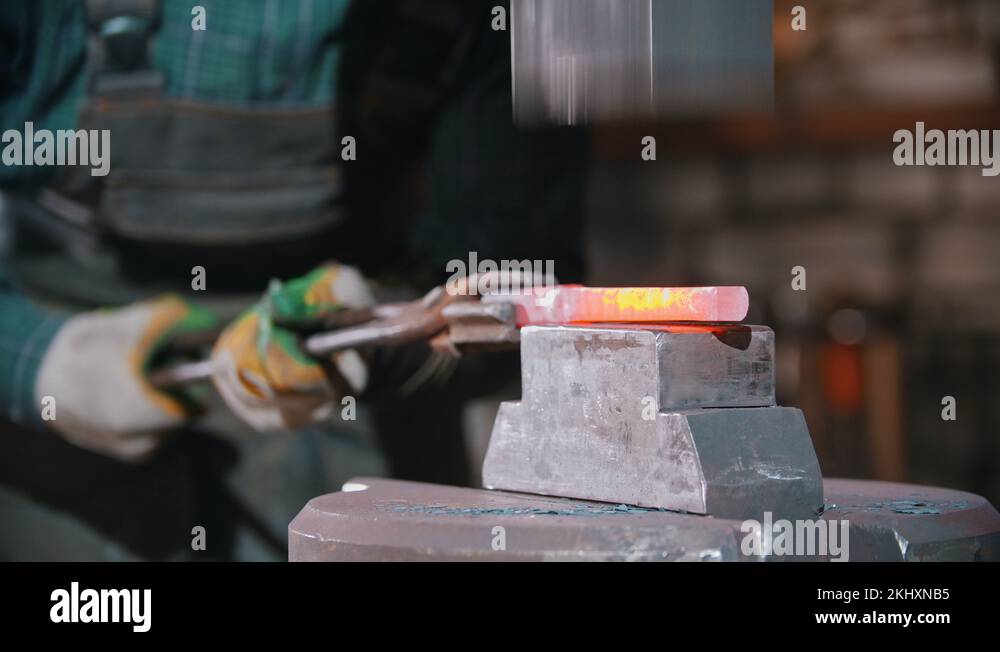 Forging an item out of hot iron using a pressure machine Stock Video ...