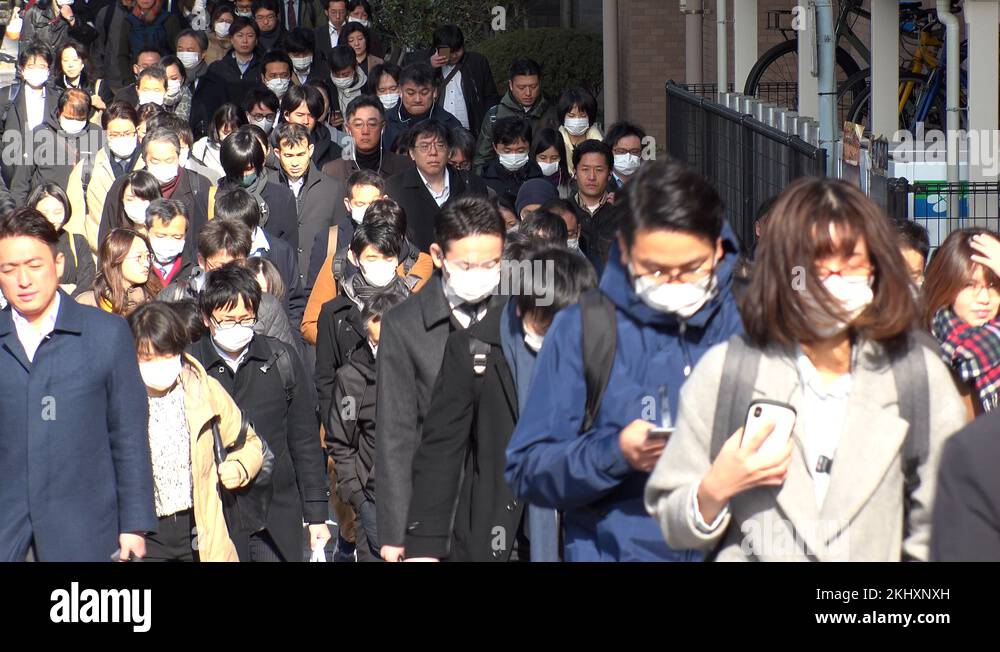 TOKYO, JAPAN : Crowd of people walking. People wearing surgical mask ...