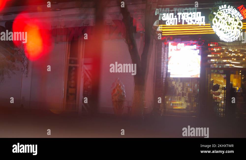 Night city street lights reflected in a shop window display Stock Video ...