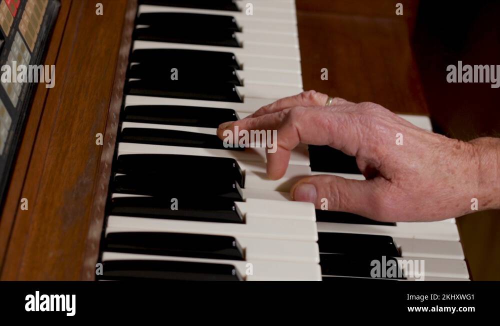 Playing organ close up old man's hand on keyboard. Modern day organ ...