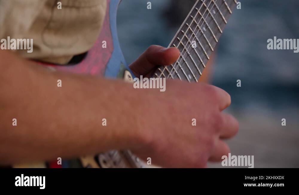 Musician fingers move across fingerboard of electric guitar. Chords for ...