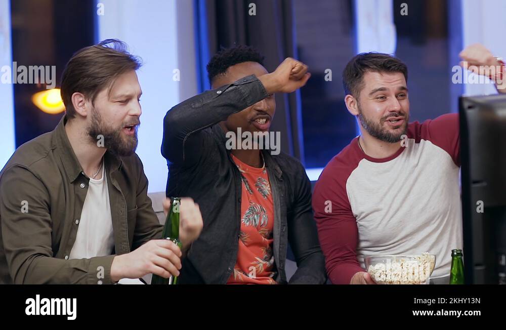 Happy stubborn diverse 30s male fans of football encouraging their ...