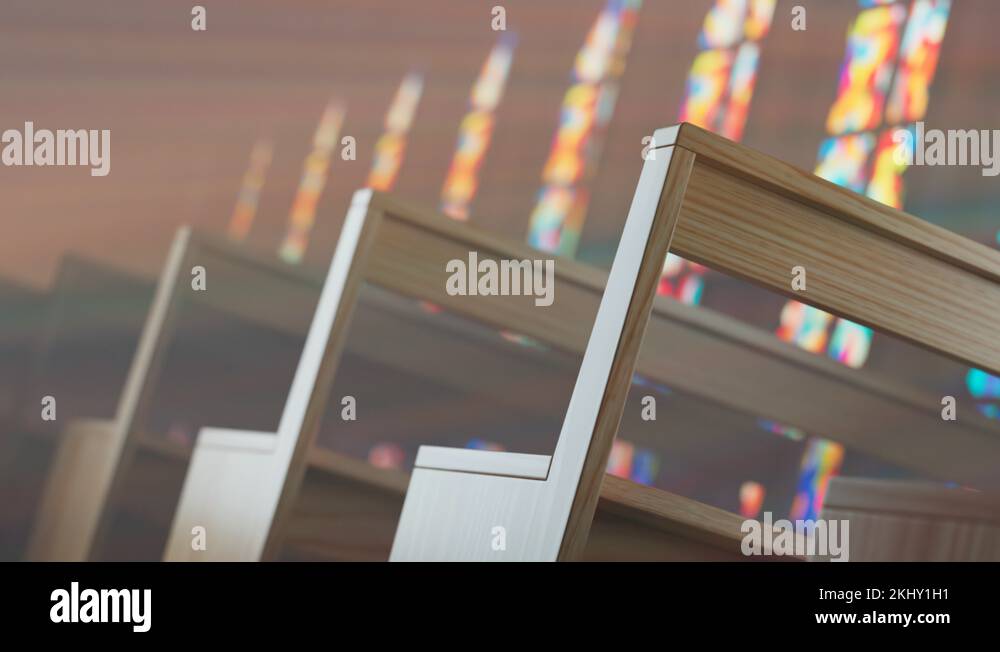 Endless rows of church benches lit by the sun through a stained glass ...