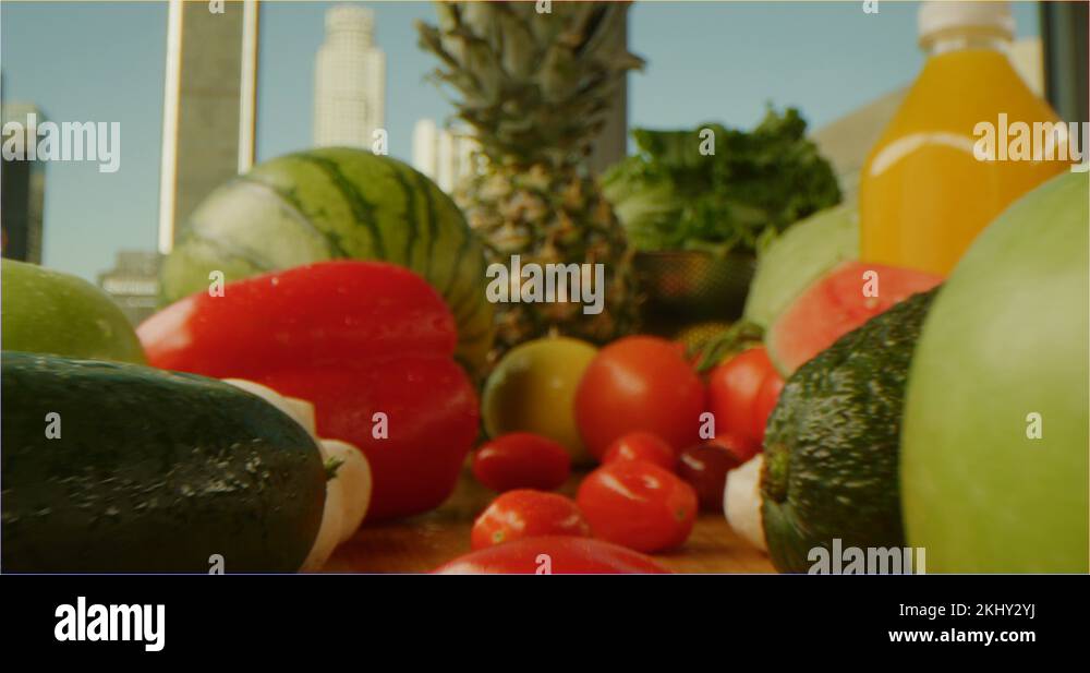 Pushing through composition of fruits and vegetables, sliding over ...