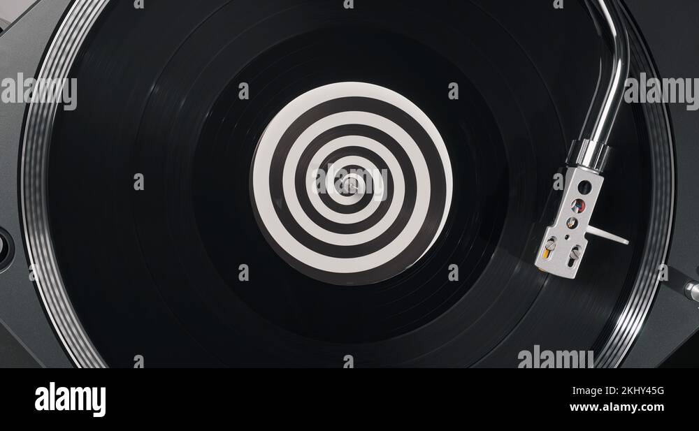 Black vinyl background spiral label center. Rotating plate close-u on ...