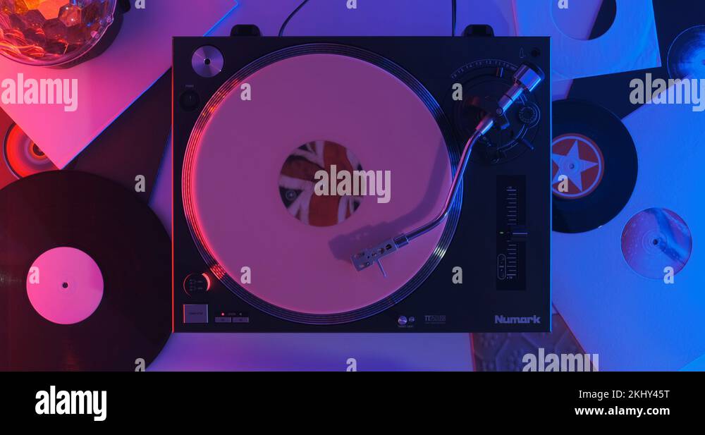 Turntable DJ player pink vinyl bright label in center vinyls blue-red ...
