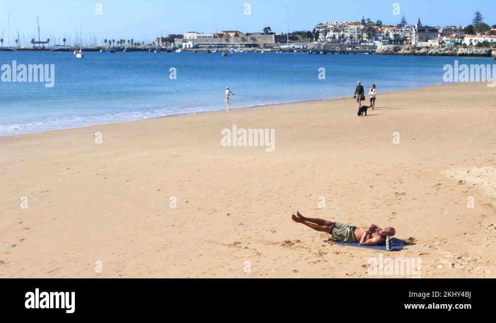 Man exercises on an almost deserted becah in Cascais, Portugal Stock ...