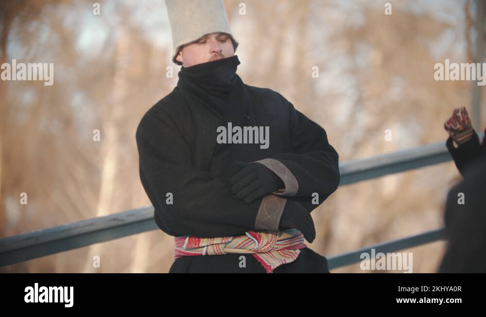 Russian folklore - men in sheepskin coats are dancing on a frosty day ...