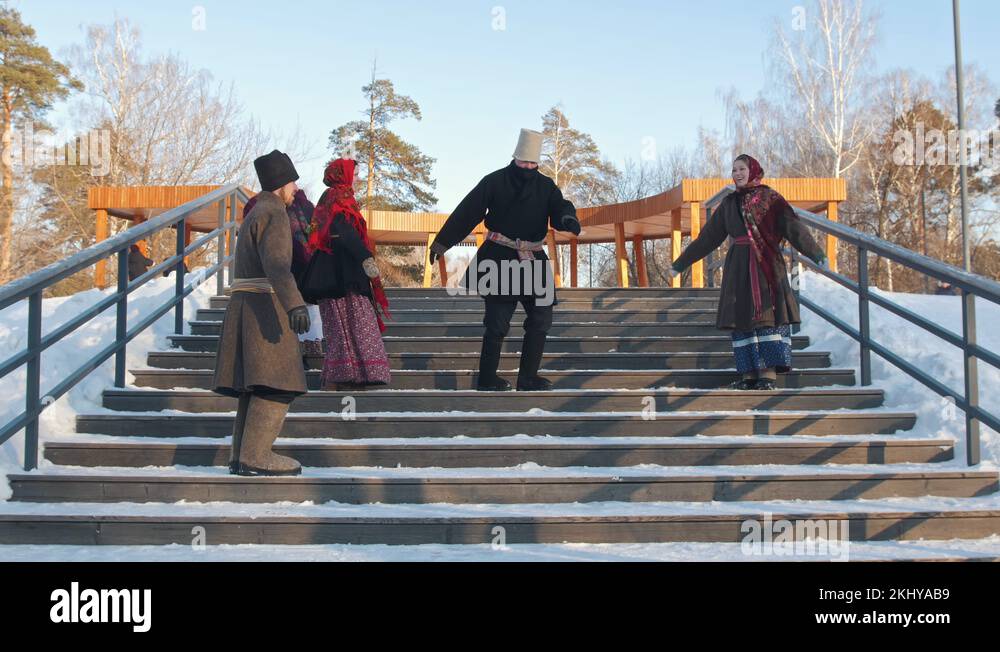 Russian folk - people in traditional Russian clothes are dancing on the ...