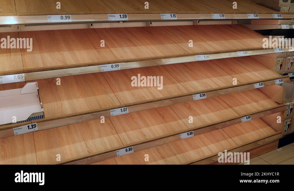 Empty bread shelves in supermarket (Signs with different type of breads ...