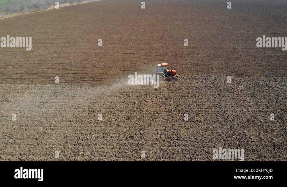Aerial view farm tractor with plow preparing land for sowing. Machine ...