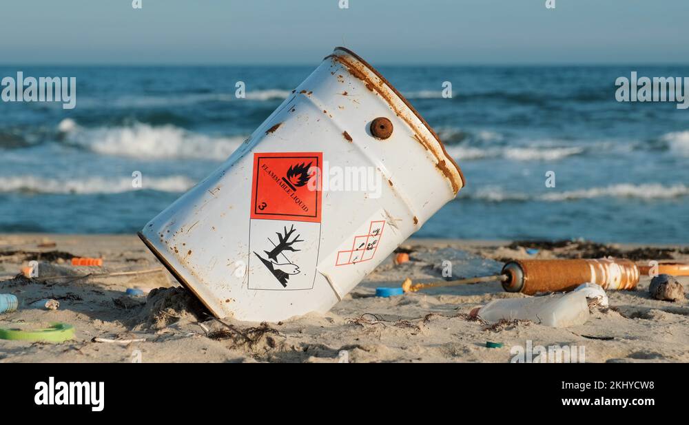Toxic rusty barrel. Spilled trash beach city. Empty used dirty plastic ...