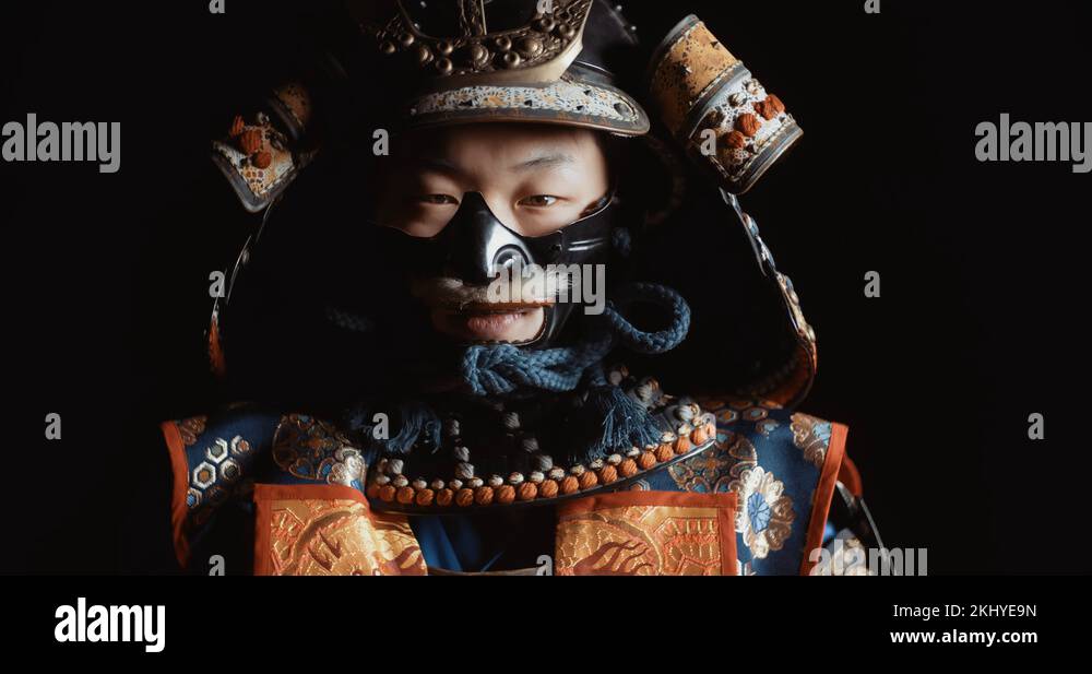 Japanese man in traditional samurai armor and authentic helmet looking ...
