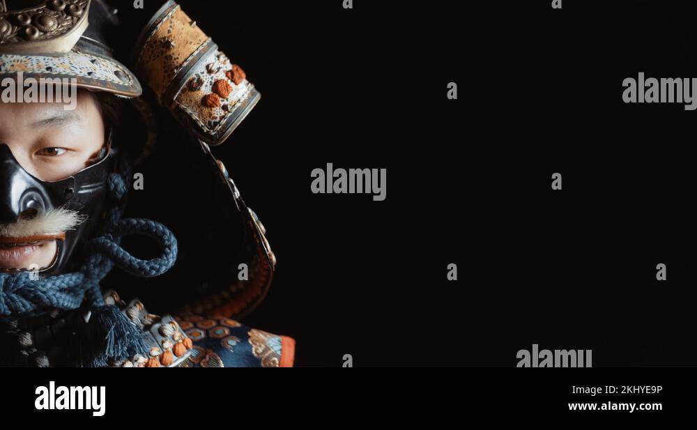 Japanese man in traditional samurai armor and authentic helmet looking ...