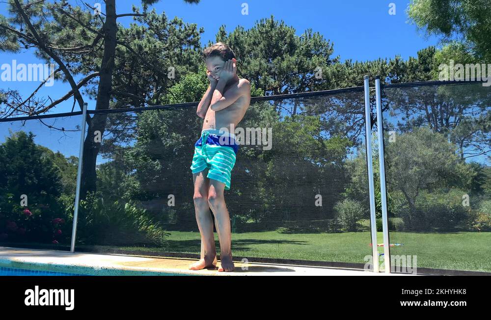 Cute goofy child boy doing funny face at pool. Kid grimacing to camera ...