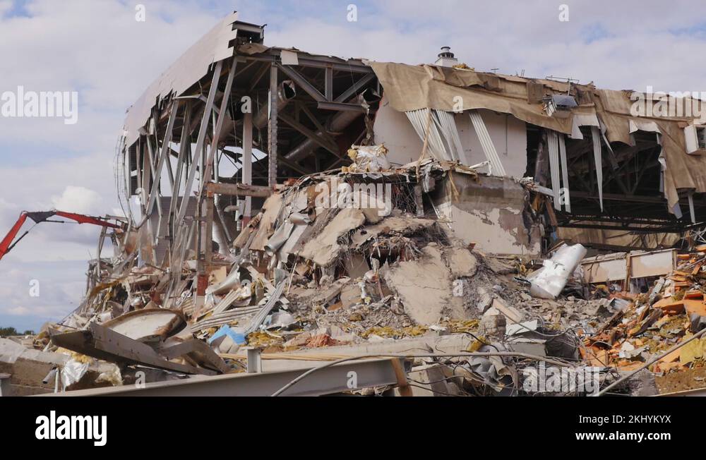excavator destroys abandoned hockey arena at demolition work Stock ...