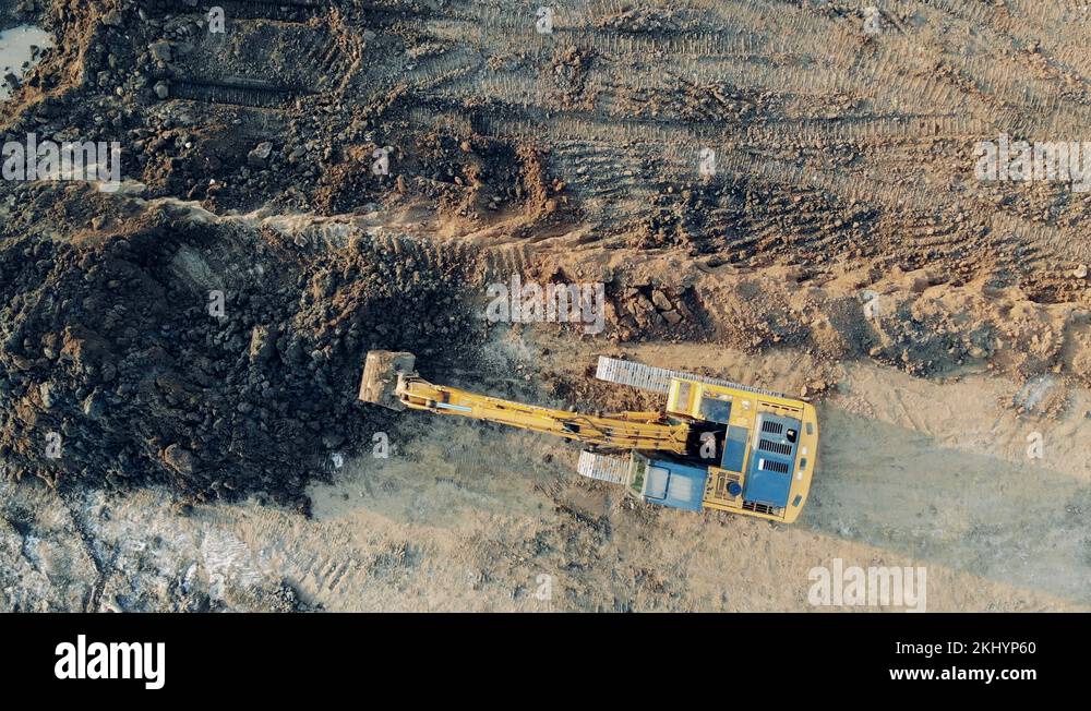 Working industrial excavator scoops earth at a career. Construction ...