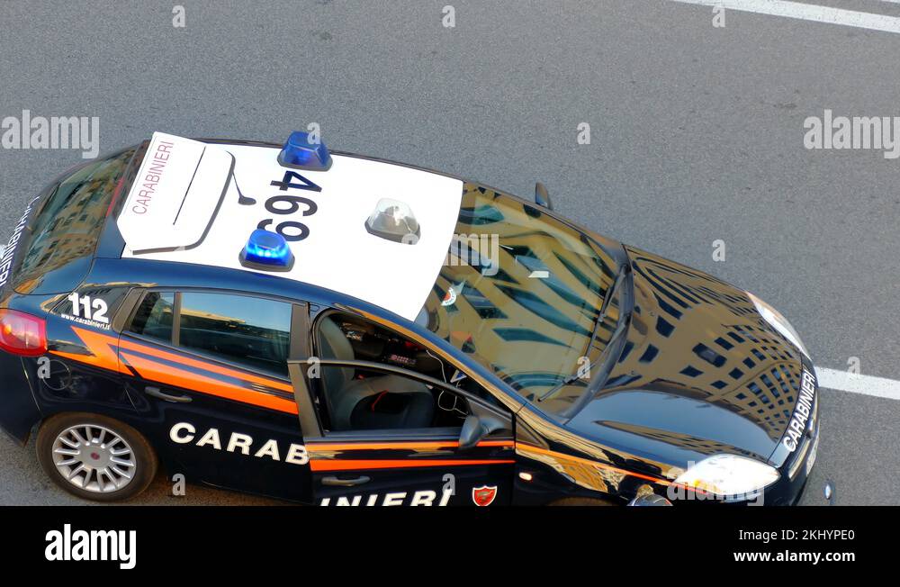 Top view of police car with blinking siren lights and open doors at the ...