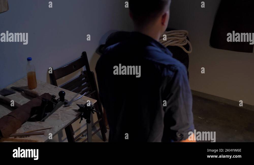 Man enters the workshop and puts on an apron Stock Video Footage - Alamy