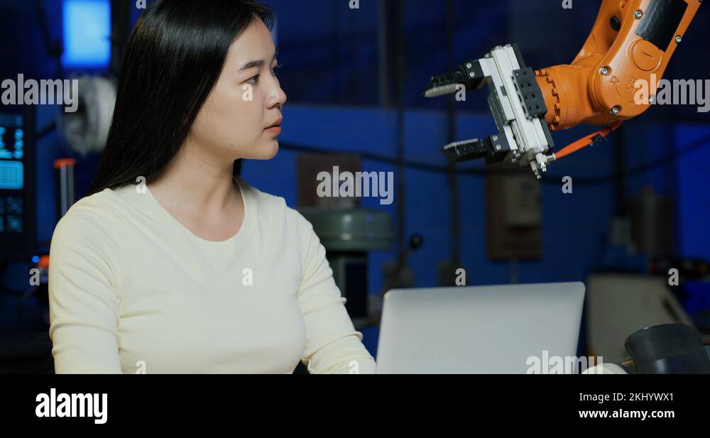Woman Engineers with Laptop Analyse Control Robotic Arm Works and Moves Stock Video Footage - Alamy