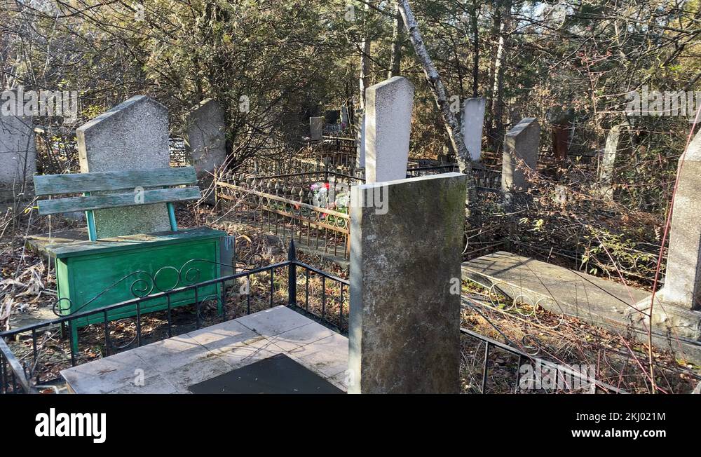 Graves with gravestones, headstones among trees, old orthodox cemetery ...
