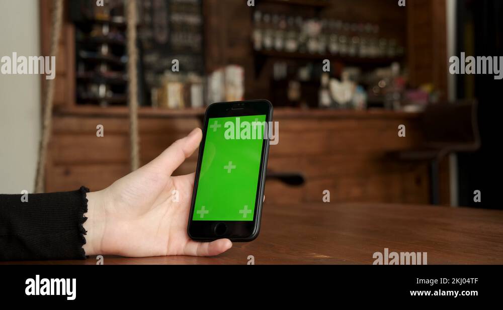Phone closeup green screen swipe. chroma key mobile bar coffee shop ...