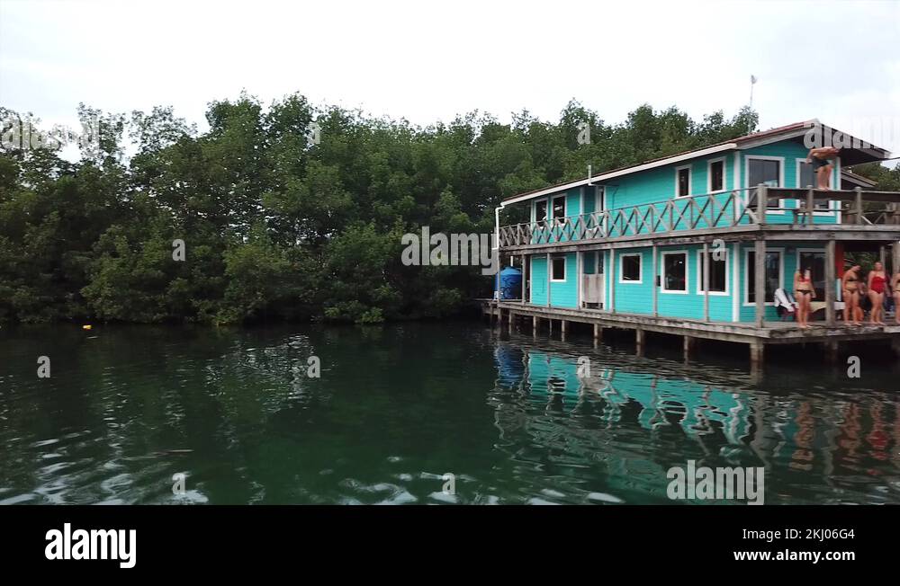 People jumping from a bungalow in the water in Bocas del Toro, Panama ...