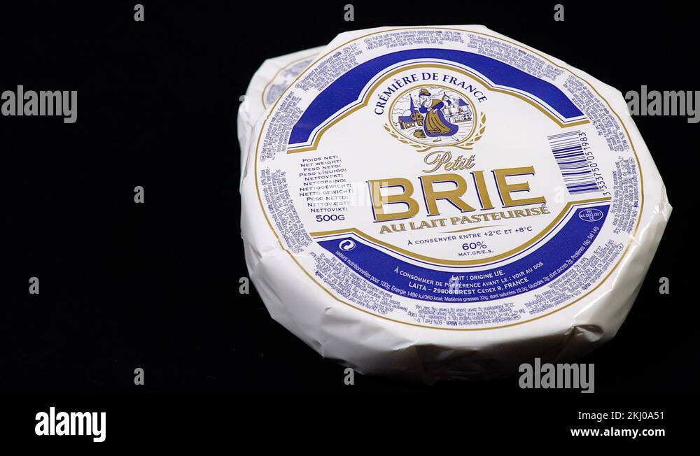 Brie cheese is a famous French cheese. Dolly shooting on a black ...