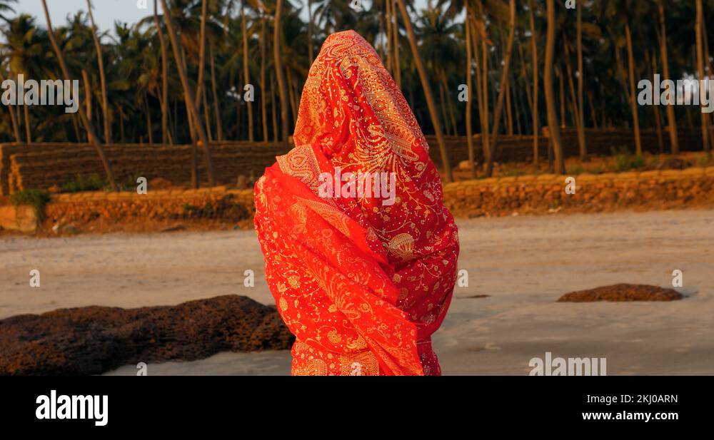 Young women wearing a red saree on the beach goa India.girl in ...