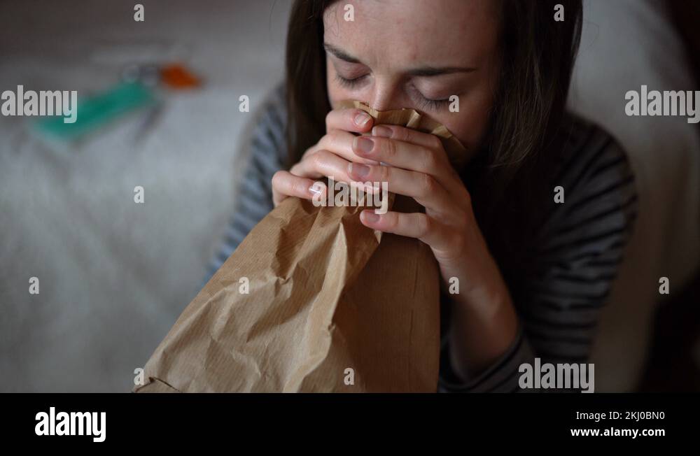 Girl having panic attack, fear and lack of air, deep breathing into ...
