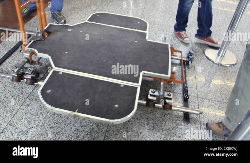 Film production crew testing camera dolly in rail in the set floor ...