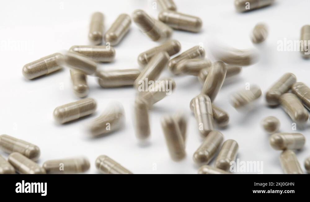 Close Up View of Natural Herbs Capsules Falling and Bouncing White ...