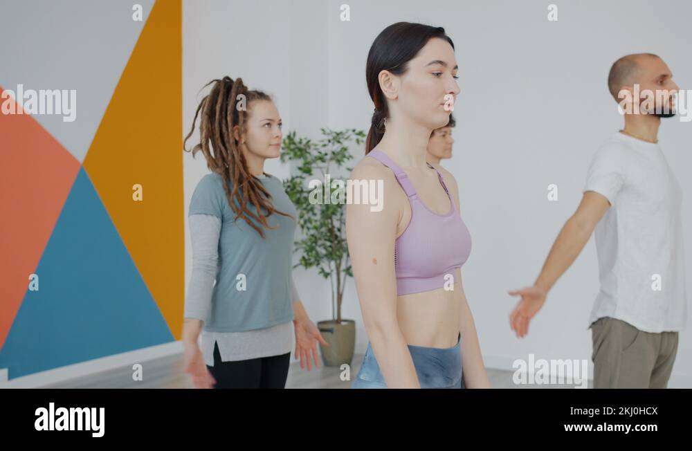 Group of students concentrated on balancing yoga asanas in healthcare ...