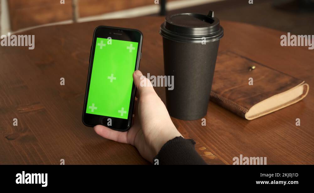 Phone closeup green screen swipe. chroma key mobile bar coffee shop ...