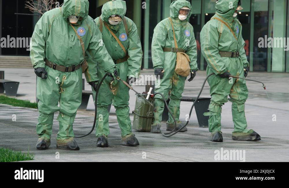 People in bio viral hazard protective suits. Disinfection and ...