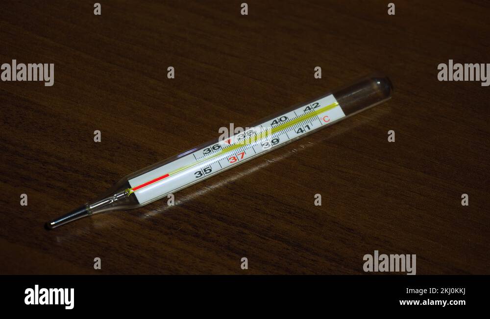 Glass thermometer on table using animation shows rising temperature up ...