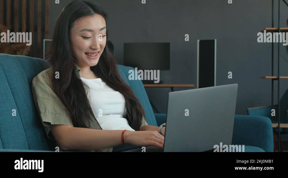 Young Chinese Woman using Laptop PC while standing at Home. Chinese ...