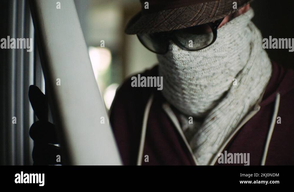A man tightens his homemade protection suit next to stair handrails in ...