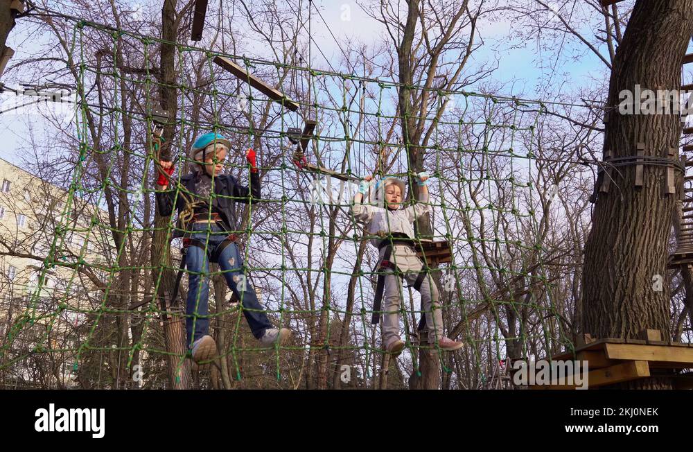 little girls climb to grid to the rope Park Stock Video Footage - Alamy