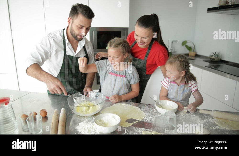 Adorable family cooking together in a kitchen with a modern interior ...