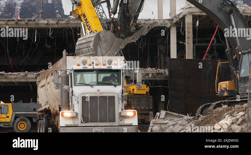 Heavy Excavator demolition into truck concrete building 4K Stock Video ...