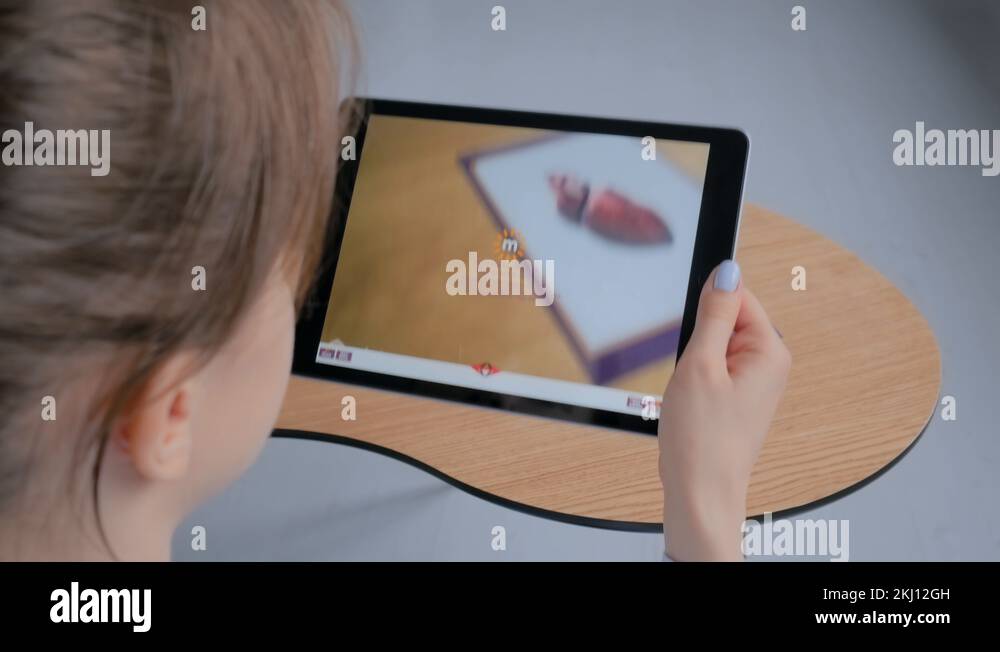 Woman using tablet device with augmented reality app - 3d model of ...