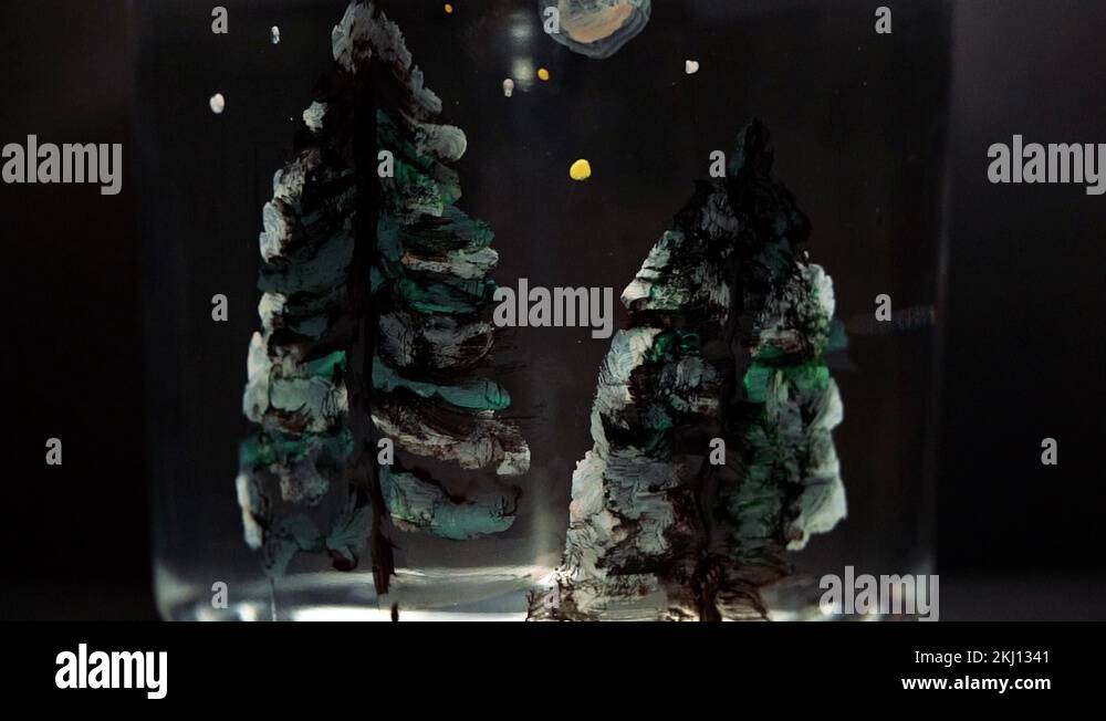 White paint floating in water tank with pine tree drawing inside ...