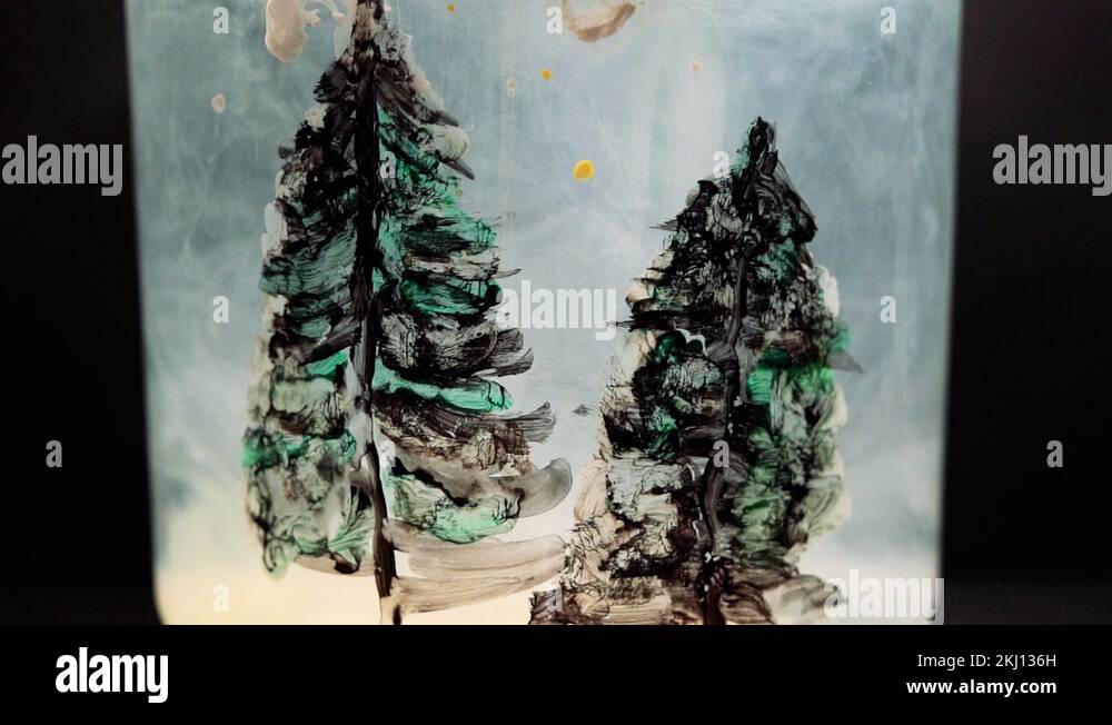 White paint floating in water tank with pine tree drawing inside ...