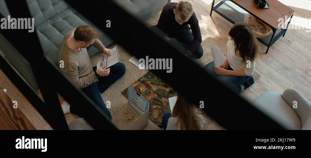 OVERHEAD Family - father, mother and two kids playing a board game ...