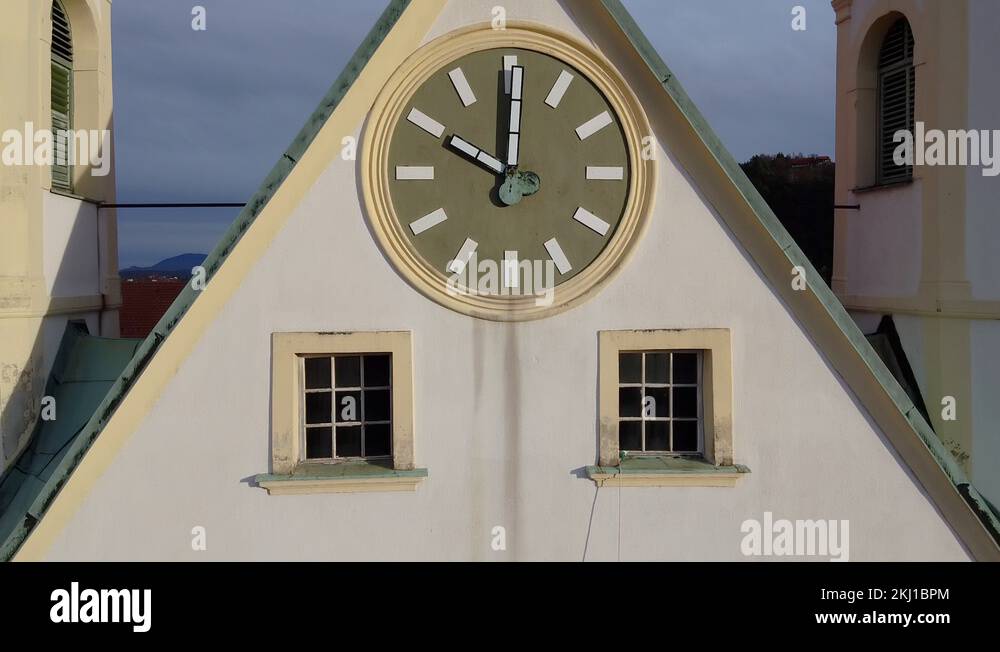 Aerial jib up of Saint Joseph church clock and revealing surrounding ...