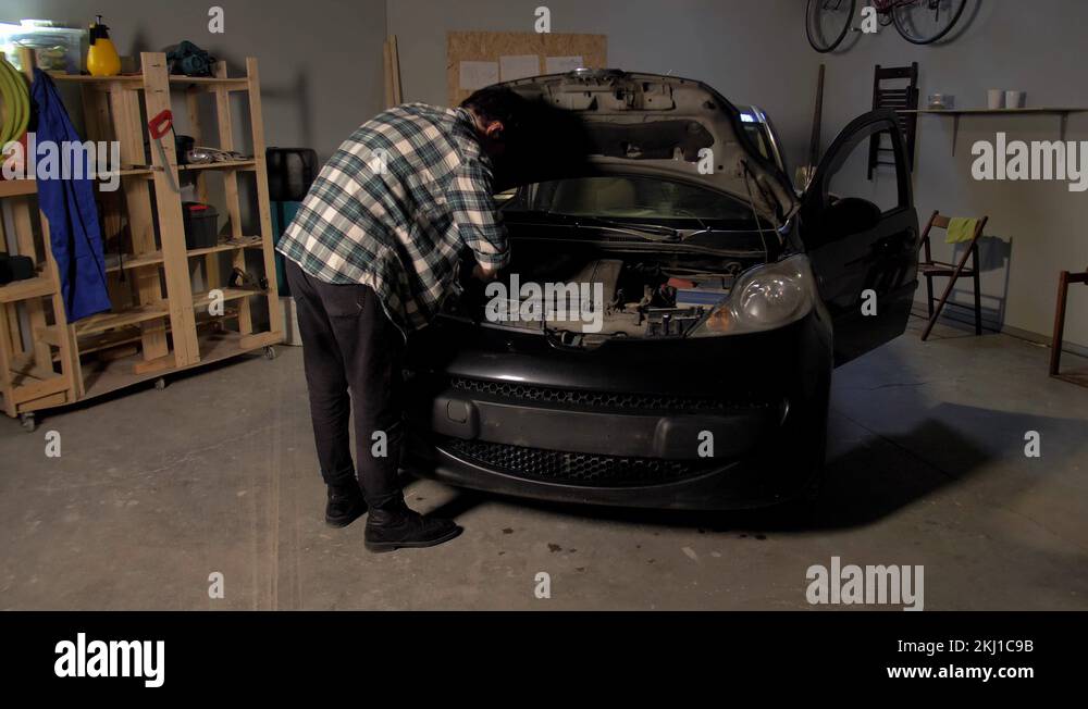 A man repairs a car in a garage Stock Video Footage - Alamy