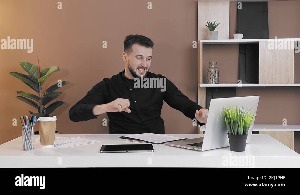 Happy office worker dancing in the workplace. Promotion and salary ...
